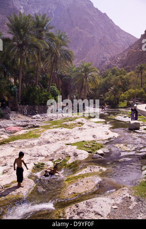 Kids play in the warm waters of Ath-Thowra springs, Nakhal, Oman Stock ...