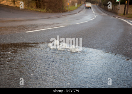 Overflowing drain in road Stock Photo - Alamy