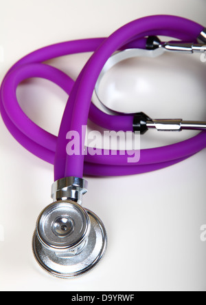 Hospital doctor with the earpieces of a stethoscope in his ears. The ...