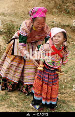 Hmong Child carrying her brother in a small village between Pakbeng and ...