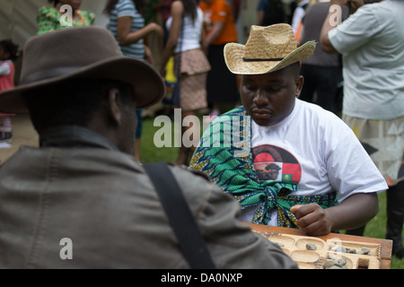 Two men play a traditional Yoruba game, Ayo Stock Photo - Alamy