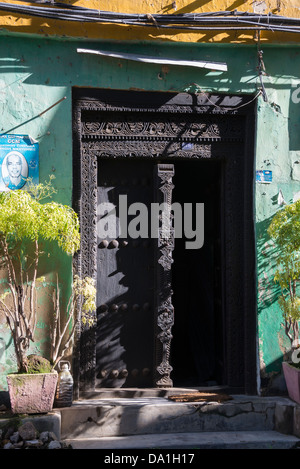 Tanzania, Zanzibar, Stone Town. An ornate window with stained glass at ...