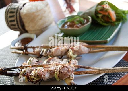 Laos, Luang Prabang. Grilled chicken feet at Hmong New Year's ...