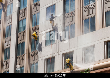 High rise building maintenance crew cleaning with pressure washer Stock ...