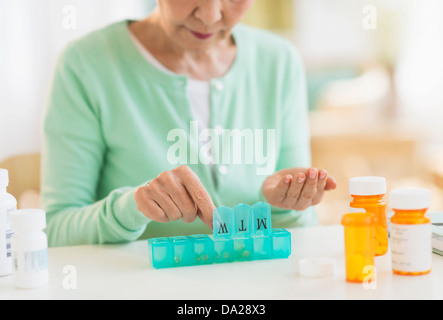 Senior woman organizing medicine in box Stock Photo - Alamy