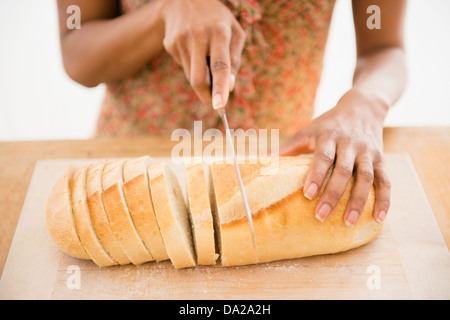 Hand cutting bread Stock Photo - Alamy