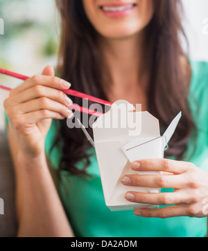 Portrait of woman eating take out food Stock Photo - Alamy