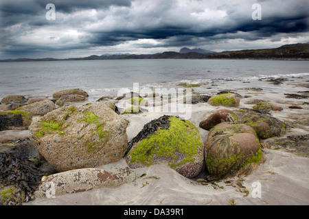 Pebbles on Garvie Beach under a dramatic dark sky, Garvie Bay, Enard ...
