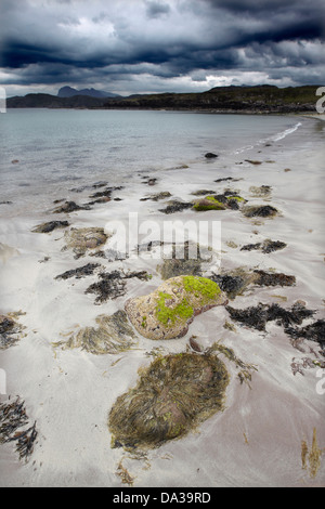 Pebbles on Garvie Beach under a dramatic dark sky, Garvie Bay, Enard ...