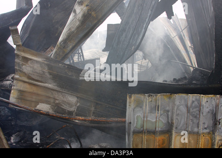 Smoke coming from a collapsed building still burning Stock Photo - Alamy