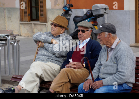 Three old Spanish men sitting on a park bench along the Paseo del ...
