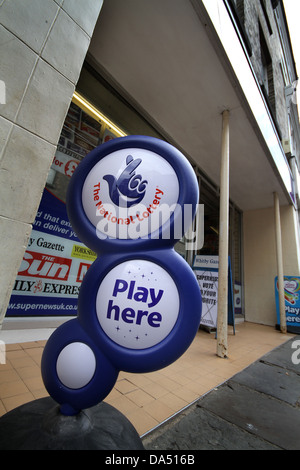 The National lottery "play here" sign outside a post office with ...