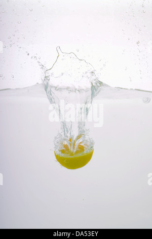 Lemon splashed into water Stock Photo - Alamy