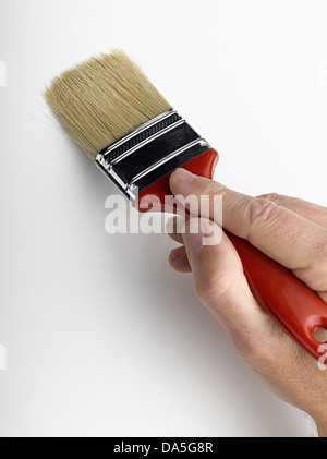 Human hand holding a brush and painting wood Stock Photo - Alamy
