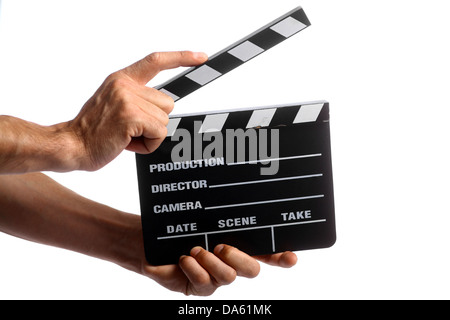 Hands holding a clapper while filming a video movie on TV. A clapper ...