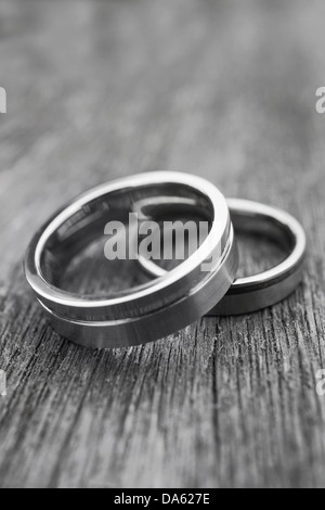 Wedding rings on old wood Stock Photo - Alamy
