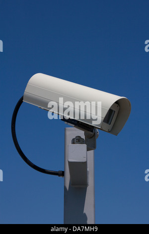 Modern outdoor surveillance camera facing right Stock Photo - Alamy
