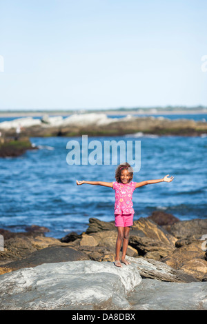 Black rocks spread out on the beach Stock Photo - Alamy