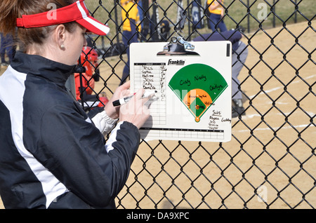 Softball coach works on her roster for the upcoming game Stock Photo ...