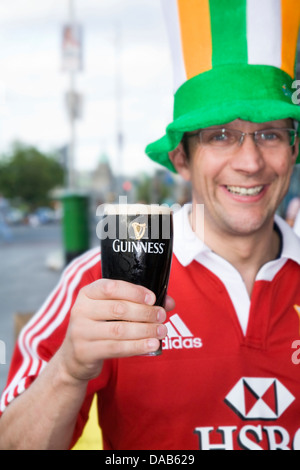 A person cheers in a street party after the Saskatchewan Roughriders ...