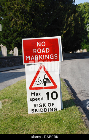 A 'No Road Markings' warning sign with 20mph speed limit enforcement ...