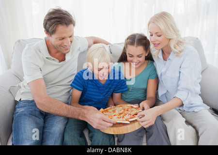Happy family sharing pizza together at home Stock Photo - Alamy