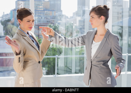 Annoyed businesswoman pointing at her rival Stock Photo - Alamy