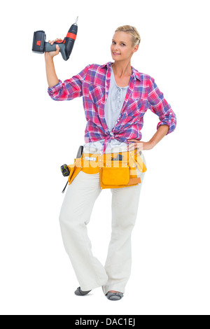 Attractive smiling handy woman standing with piggybank and pointing ...