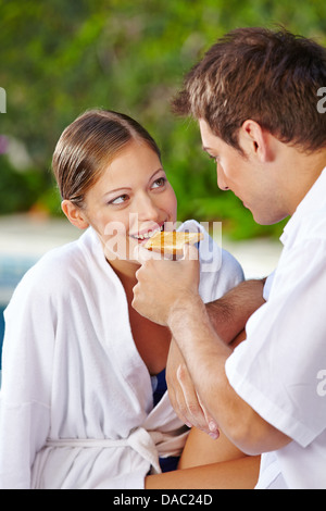 Young man and woman eating toast Stock Photo - Alamy