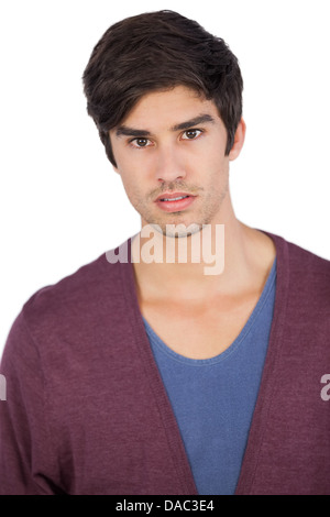 Serious young man looking at camera on white background Stock Photo - Alamy
