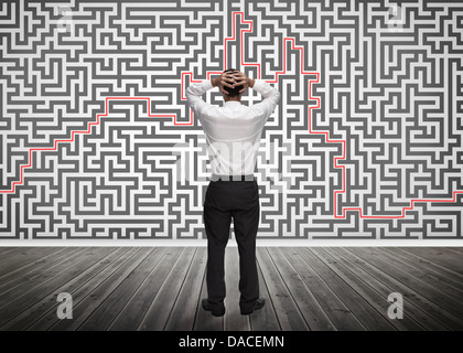 Confused businessman looking at a maze Stock Photo - Alamy