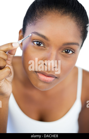 Concentrated woman using tweezers Stock Photo - Alamy