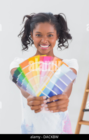 Excited woman showing colour charts and pointing Stock Photo - Alamy