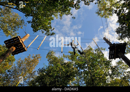 Boy climbing rope tower in Spruce Tree Castle at Rosenalm park near ...
