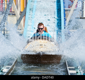 log flume water ride at the fun fair man and child on the ride Stock ...