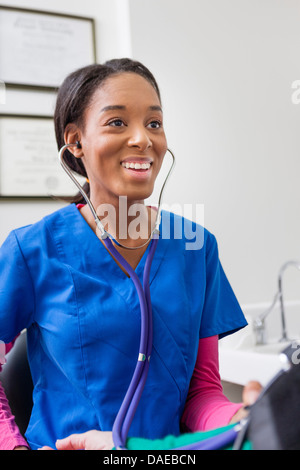 Nurse using stethoscope Stock Photo - Alamy