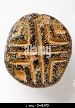 This ancient stamp seal, crafted in bronze, features intricate designs ...