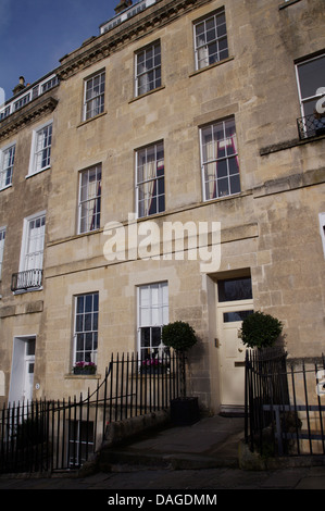 Clipped bay trees on either side of blue front door of Victorian house ...