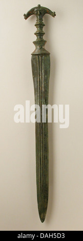 This ancient dagger, crafted from bronze, features intricate details ...