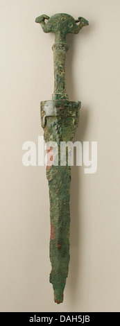 This dagger, crafted from bronze, features a finely cast blade and ...