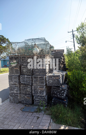 Commercial seafood shellfish traps and floats stacked by the roadside ...