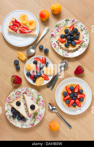 Assortment of fresh cakes with cream and berries on shop counter for ...