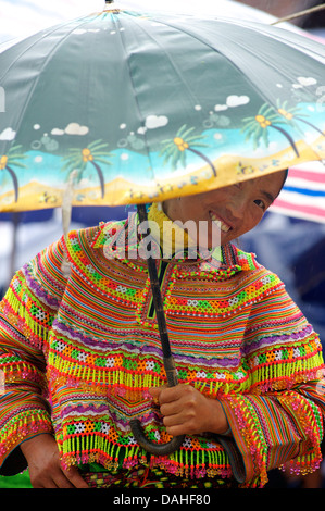 Flower Hmong woman peering from underneath her umbrella. Bac Ha market ...