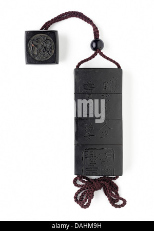 This set includes an inro, ojime, and netsuke, which are traditional ...