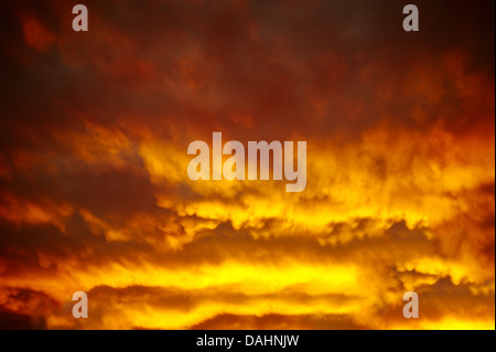 Dramatic background with cloudy sky at burning sun Stock Photo - Alamy