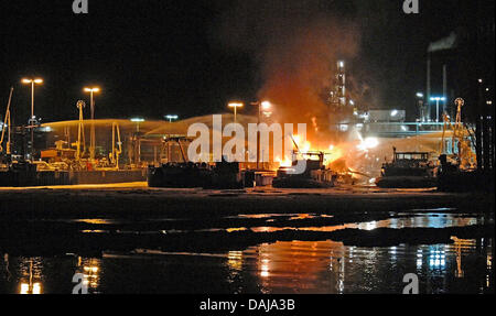 An oil-tanker is on flames in the harbour of BP refinery in Lingen ...