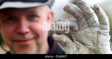 Battle field archeologist Glenn Foard uses a metal detector and a spade ...
