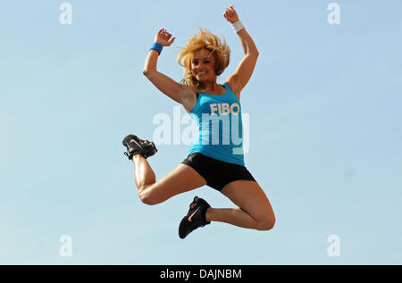 Spanish fitness star Jessica Exposito jumps into the air during a ...