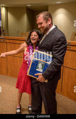 A happy graduate receives her diploma at her Adult Transition Program ...