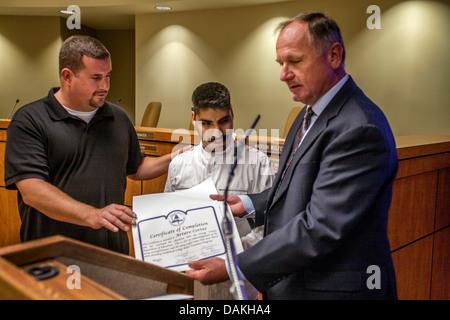 A happy graduate receives a special award at his Adult Transition ...
